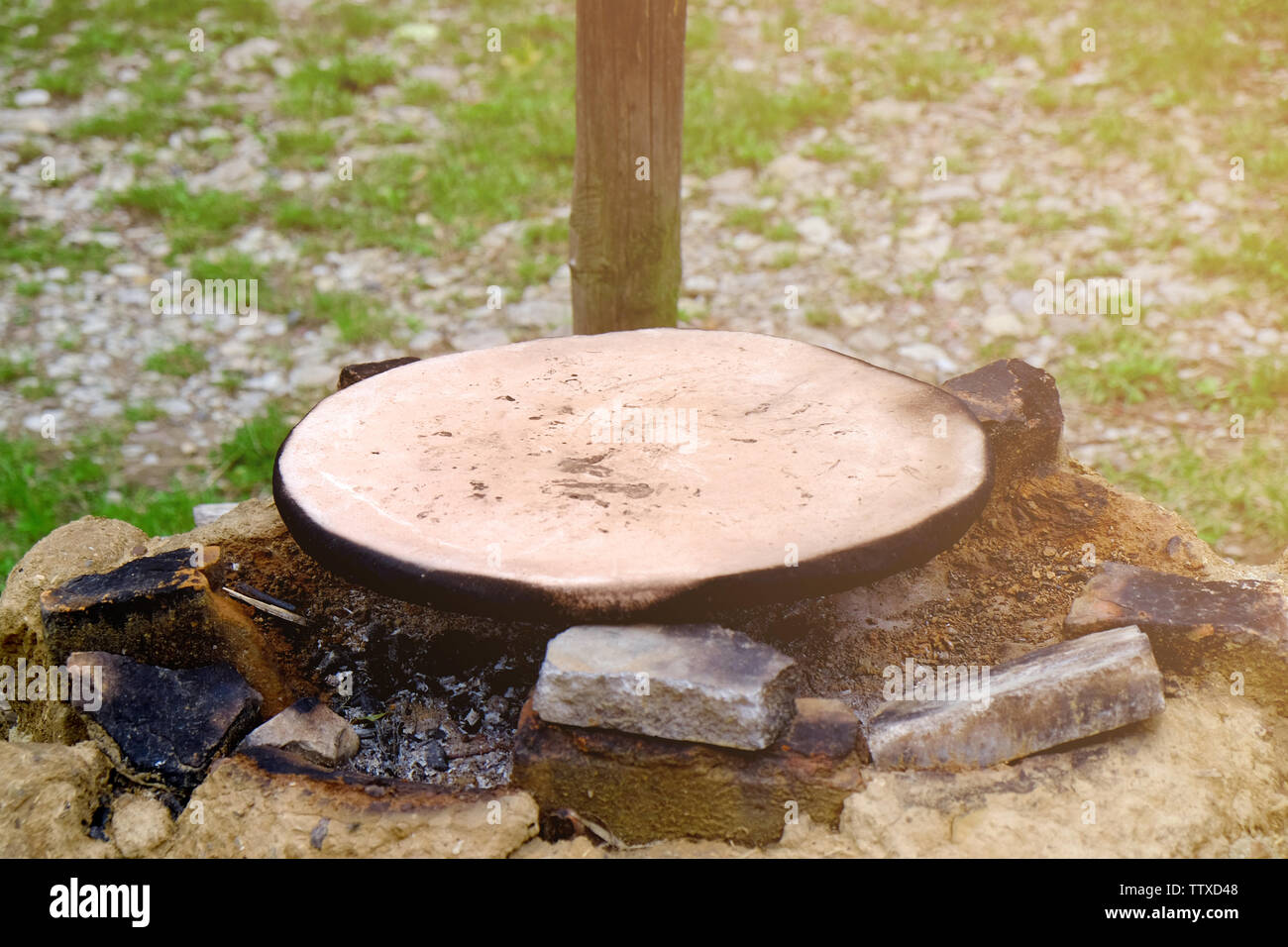 Stone plate for preparation food on fire outdoors Stock Photo - Alamy