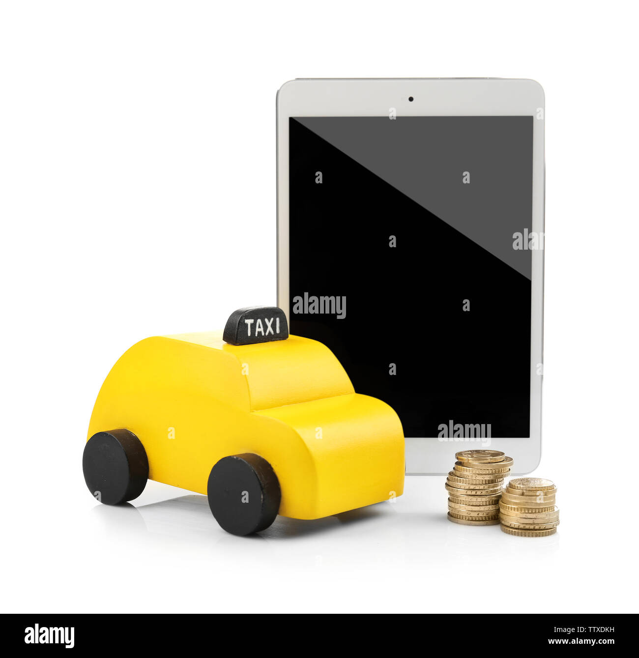 Yellow toy taxi cab, tablet and coins isolated on white Stock Photo - Alamy