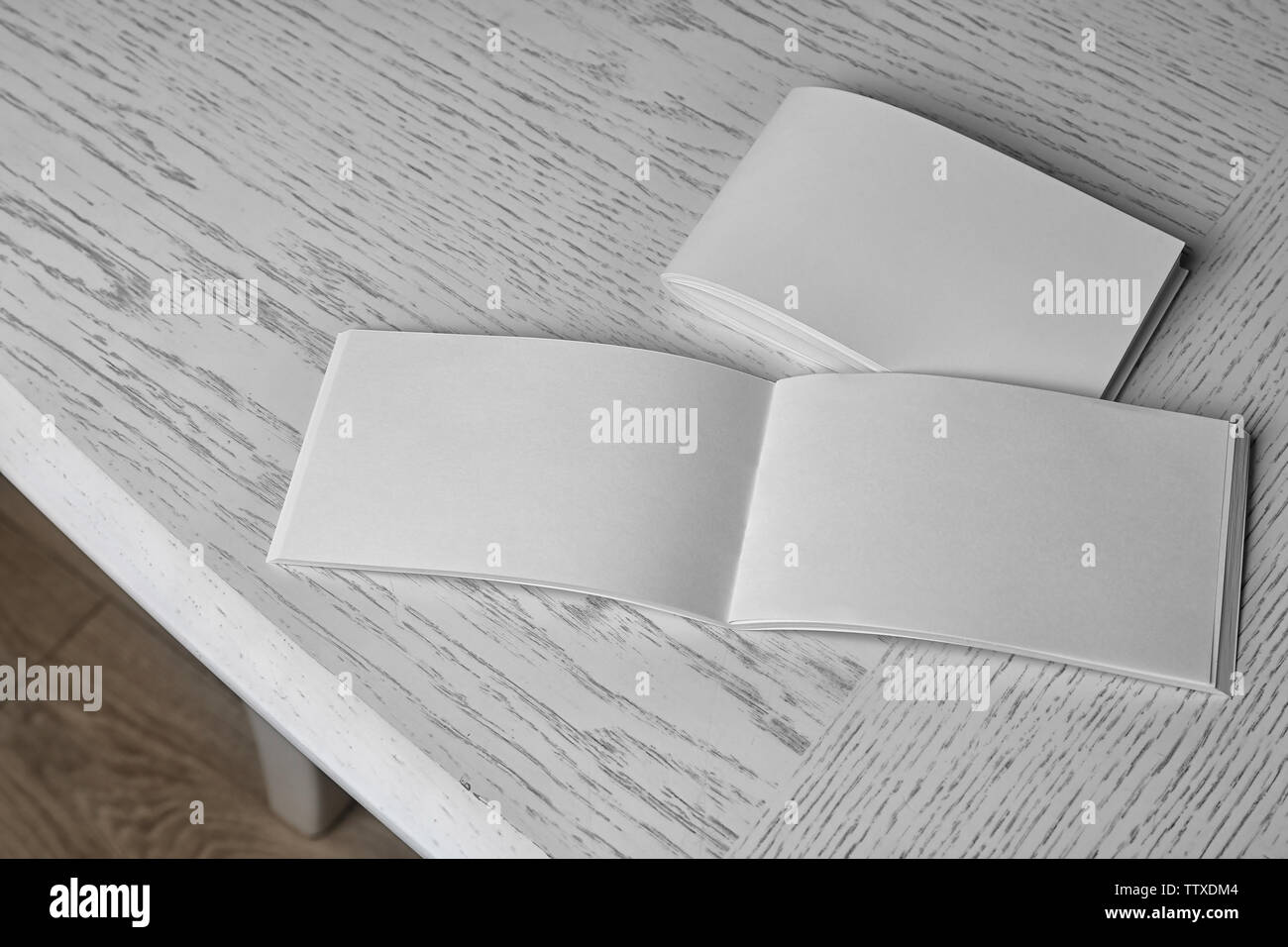 Blank brochures on wooden table Stock Photo - Alamy