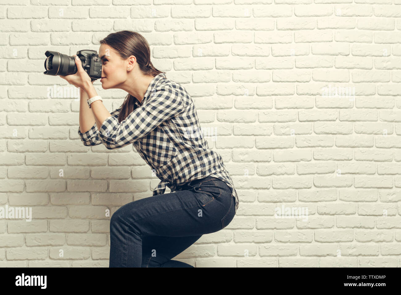 Pretty woman is a professional photographer with dslr camera Stock ...