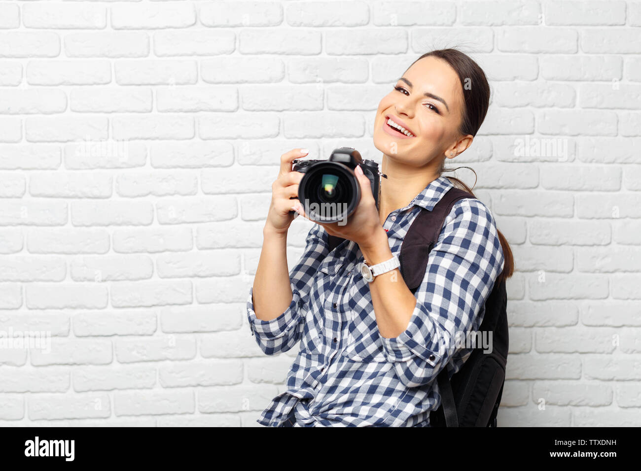 Pretty woman is a professional photographer with dslr camera Stock ...