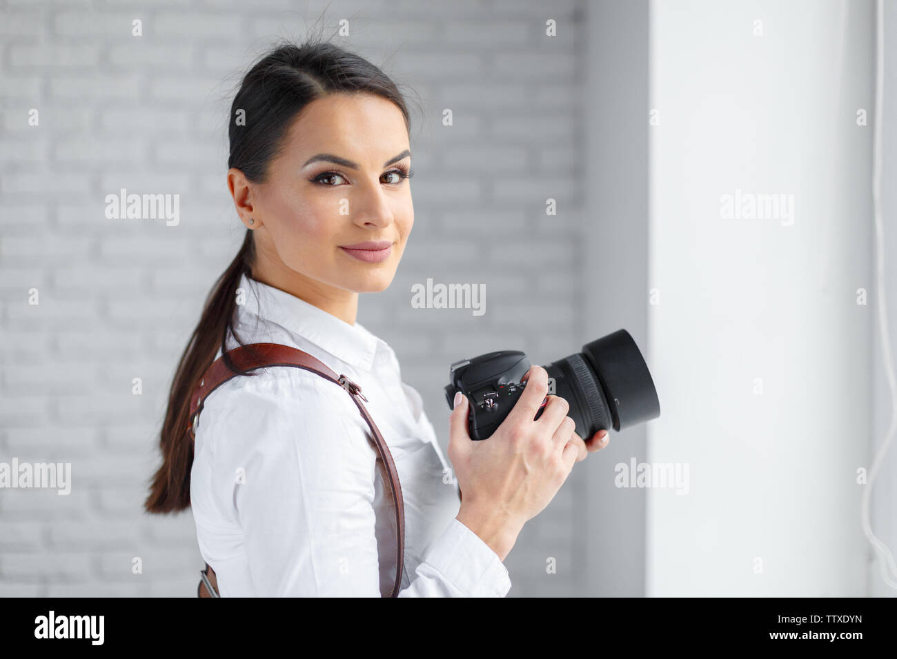 Pretty woman is a professional photographer with dslr camera Stock ...