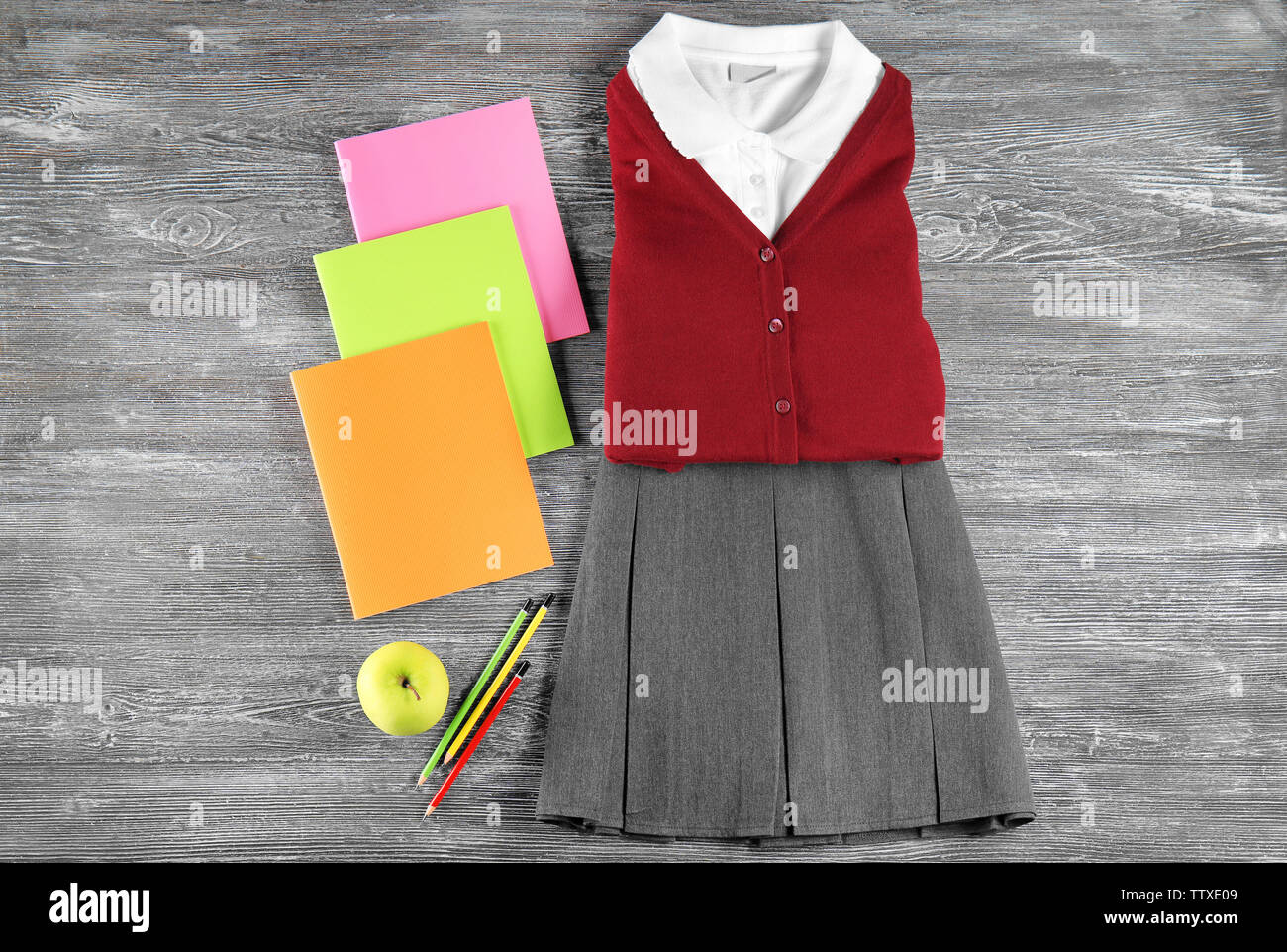 School uniform and accessories on wooden background Stock Photo - Alamy