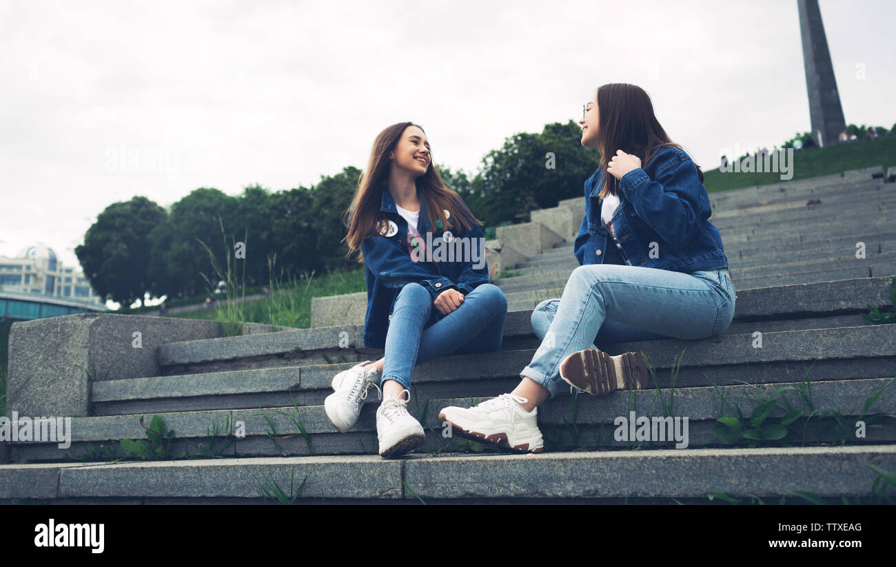 Friends having conversation in park hi-res stock photography and images ...