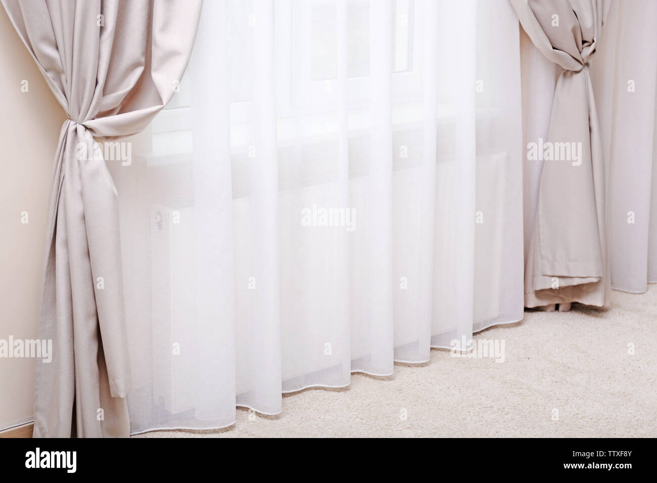 Window with new elegant curtain Stock Photo - Alamy