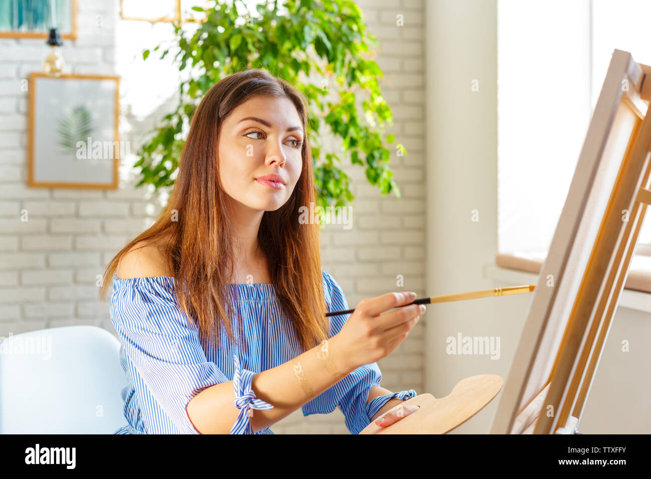 Creative woman working in art studio Stock Photo - Alamy