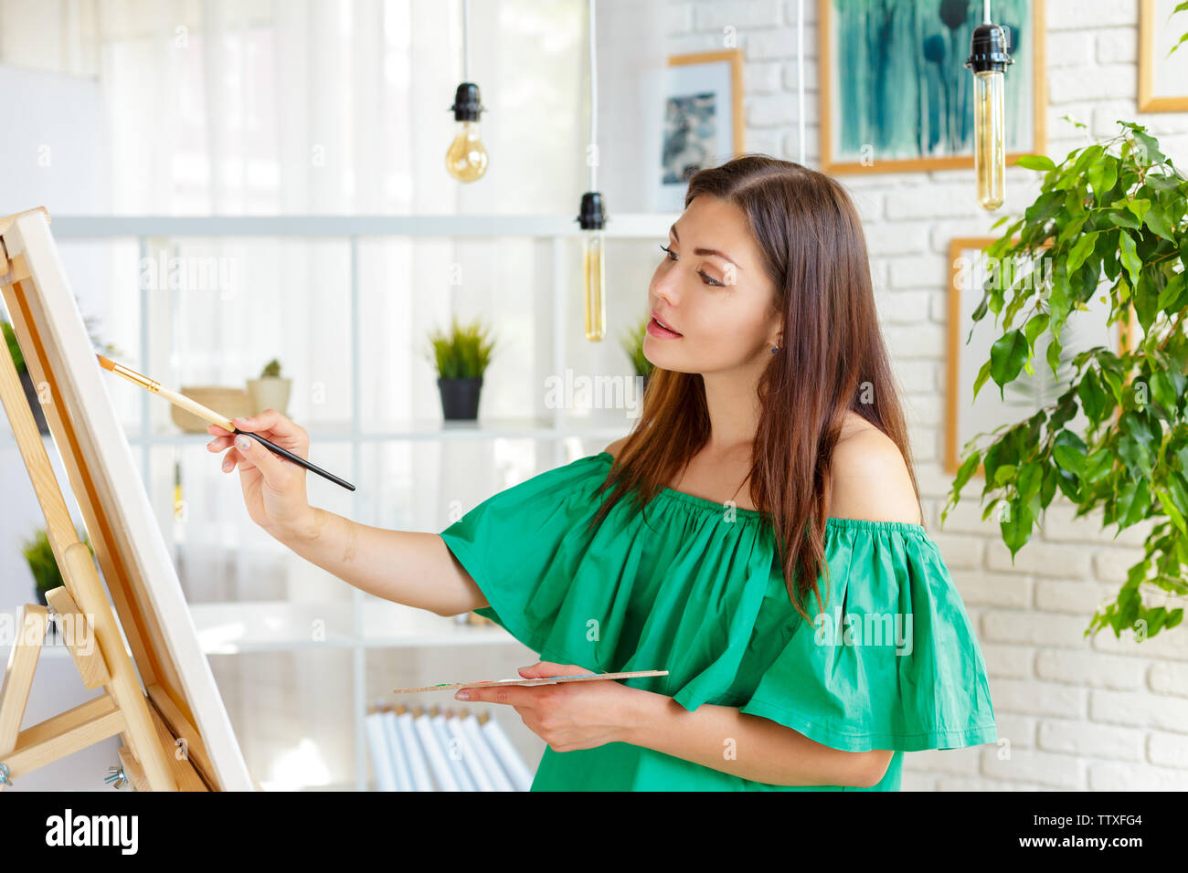 Creative woman working in art studio Stock Photo - Alamy