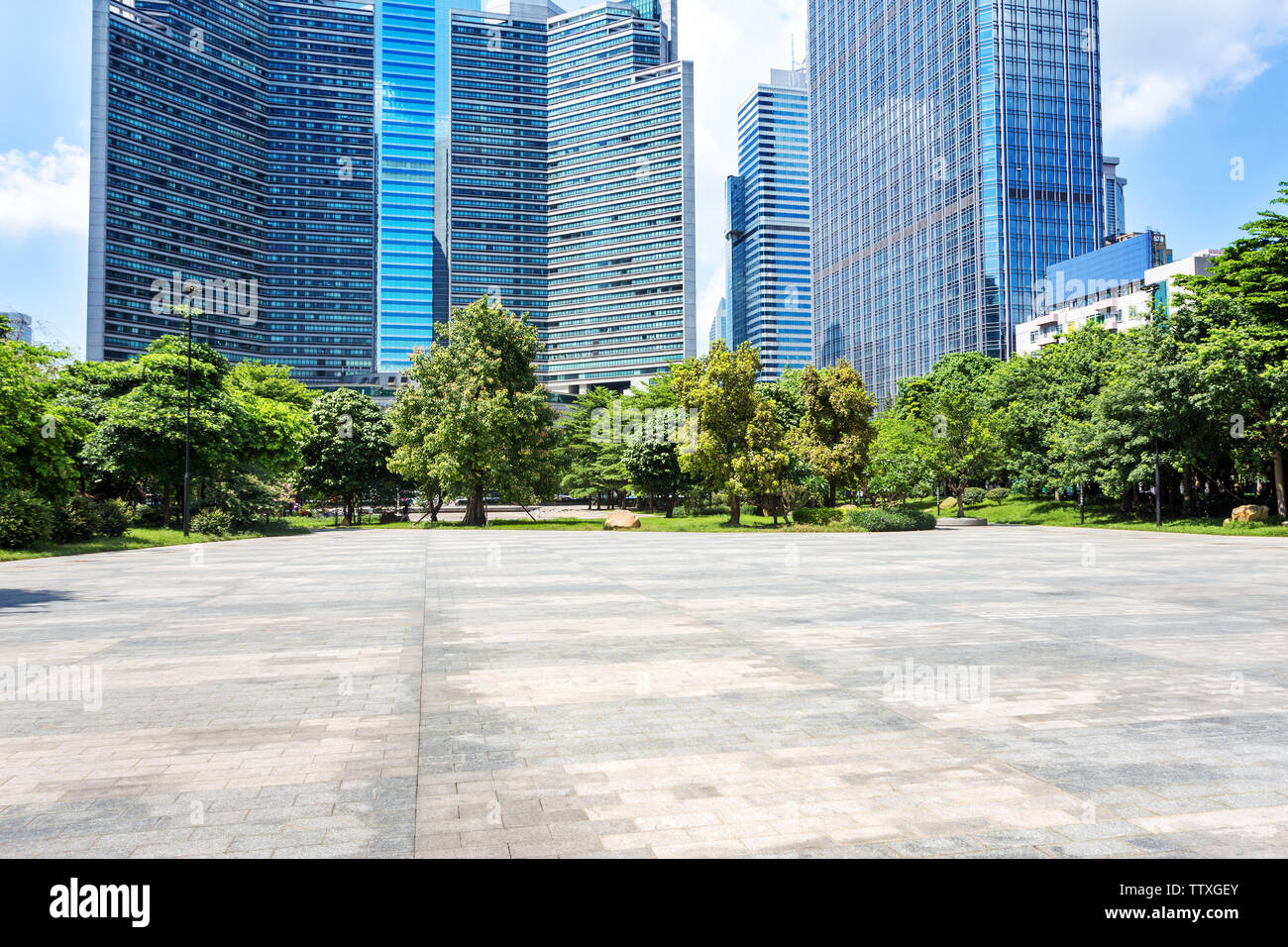 modern square and skyscrapers under blue sky Stock Photo - Alamy
