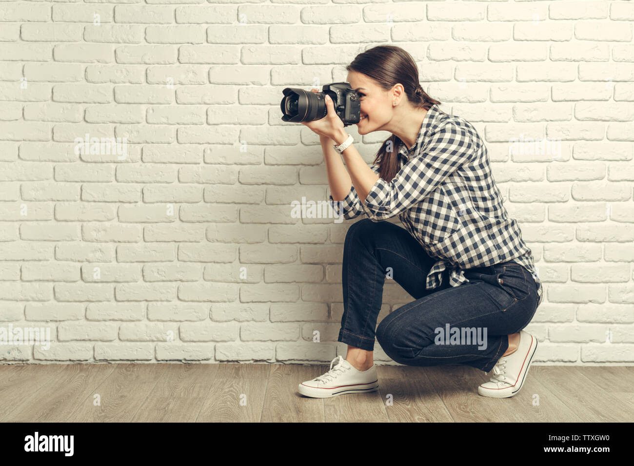 Pretty woman is a professional photographer with dslr camera Stock ...