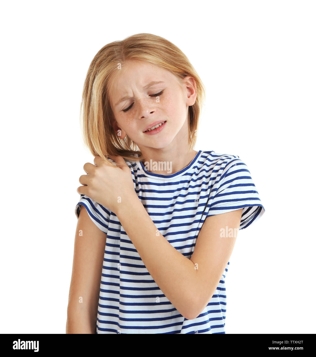 Little girl with pain in shoulder on white background Stock Photo - Alamy