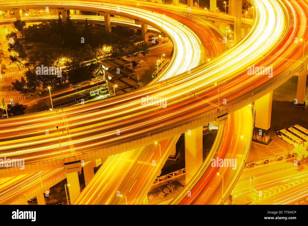 illuminated road intersection and traffic trails Stock Photo - Alamy
