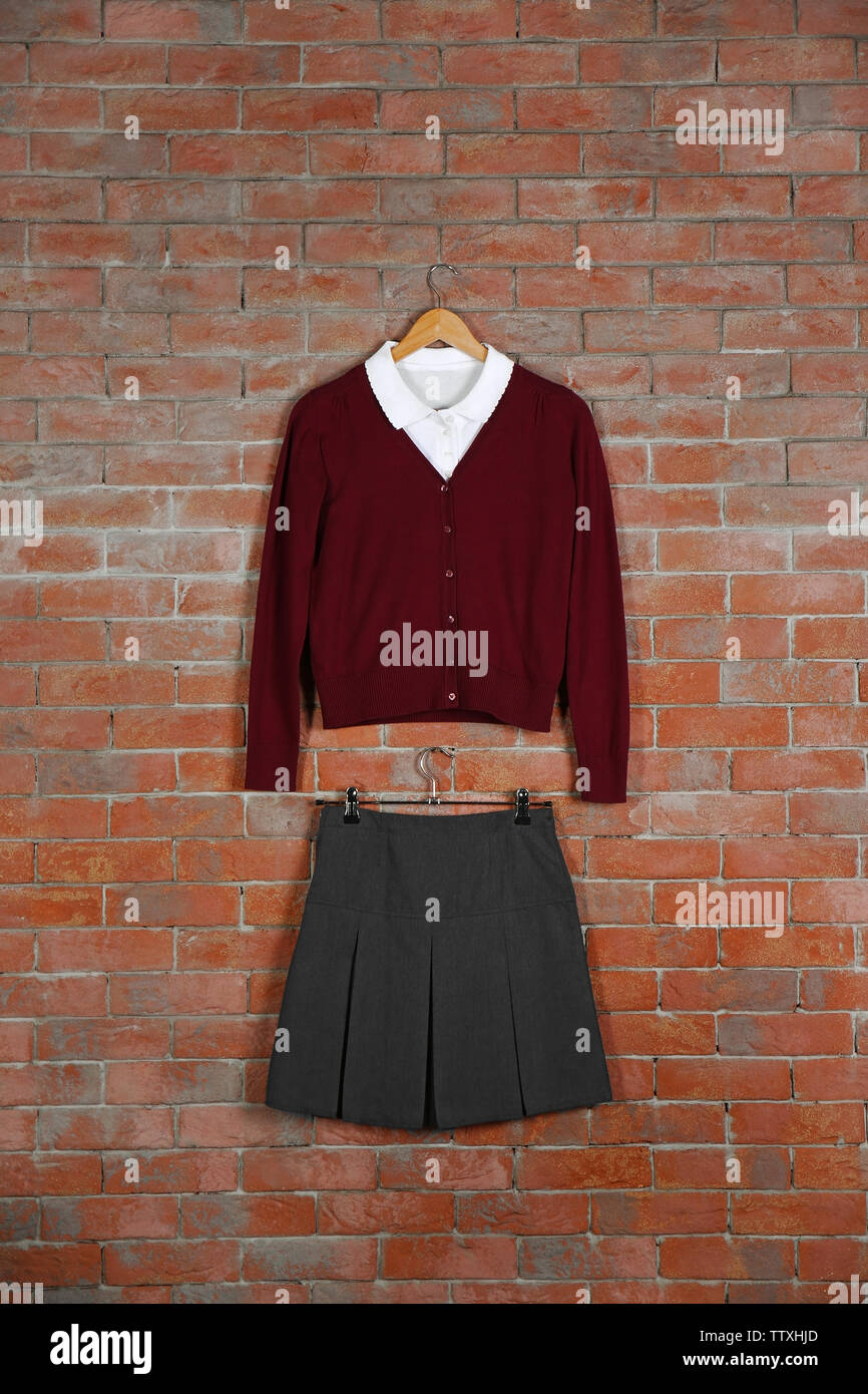 School uniform on brick wall background Stock Photo - Alamy