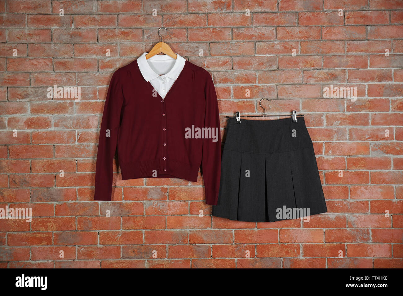 School uniform on brick wall background Stock Photo - Alamy
