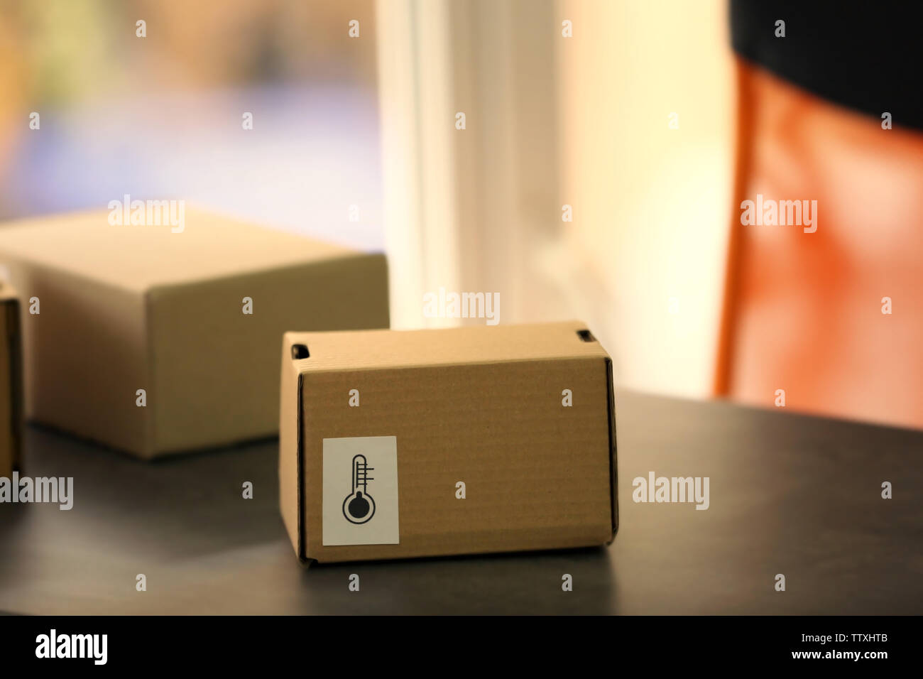 Carton boxes on table in room Stock Photo - Alamy