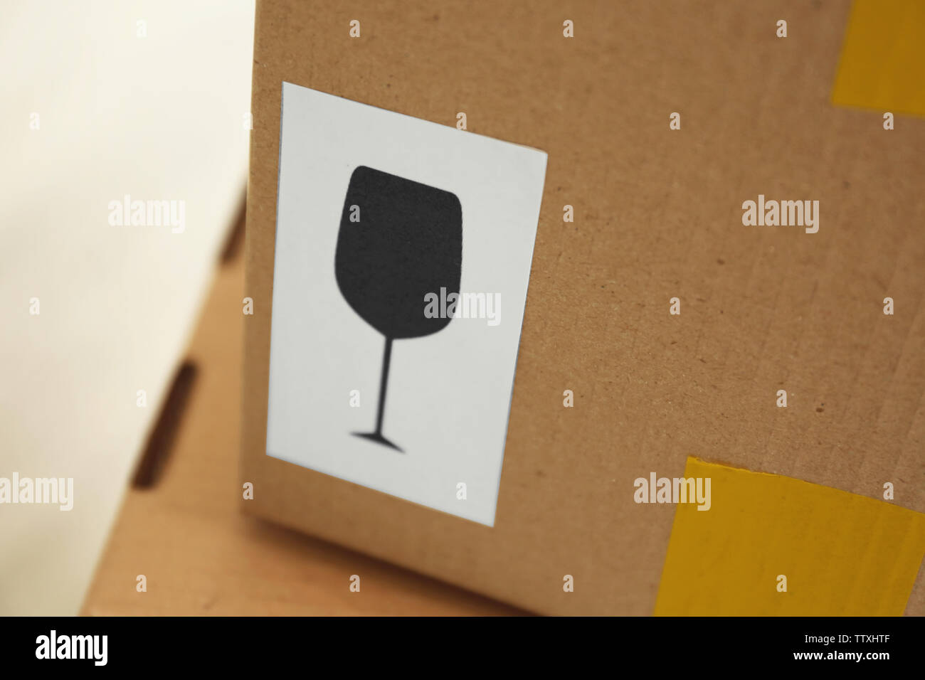 Carton boxes with warning sign, closeup Stock Photo - Alamy