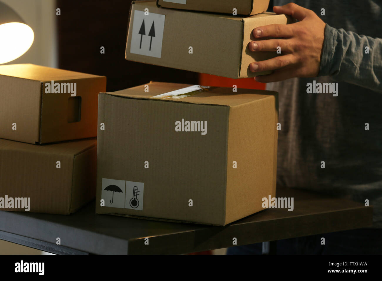 Man holding boxes sign hi-res stock photography and images - Alamy