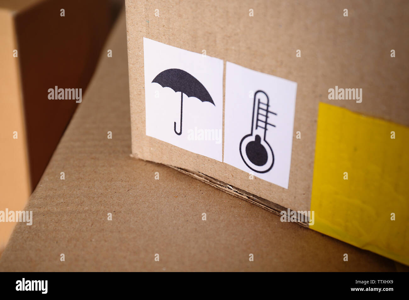Carton boxes with warning sign, closeup Stock Photo - Alamy