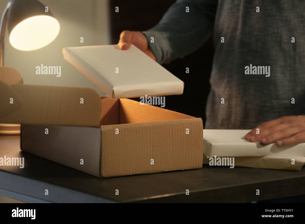 Delivery man putting carton boxes hi-res stock photography and images ...