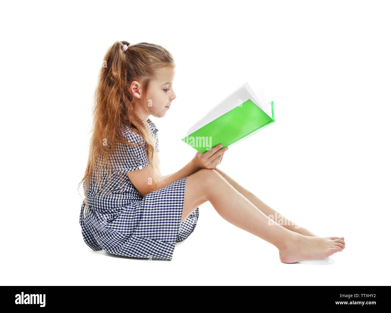 Cute girl reading book on white background Stock Photo - Alamy