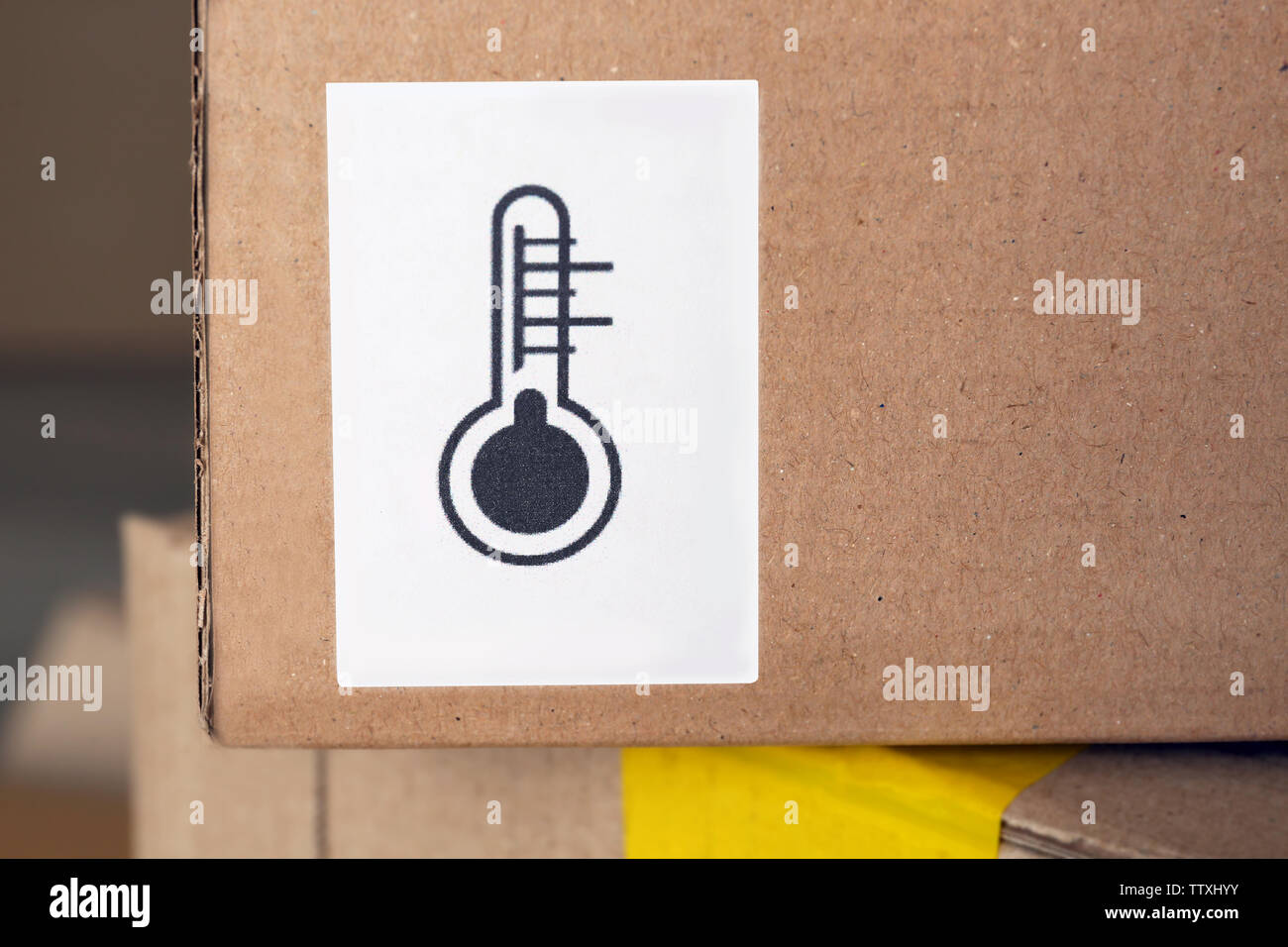 Carton boxes with warning sign, closeup Stock Photo - Alamy