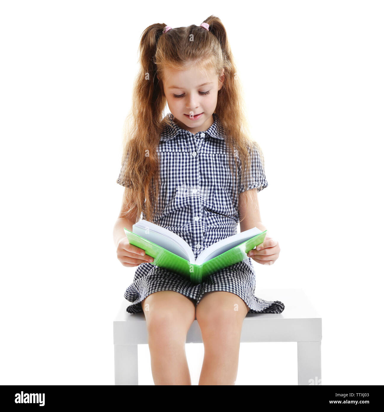 Cute girl reading book on white background Stock Photo - Alamy