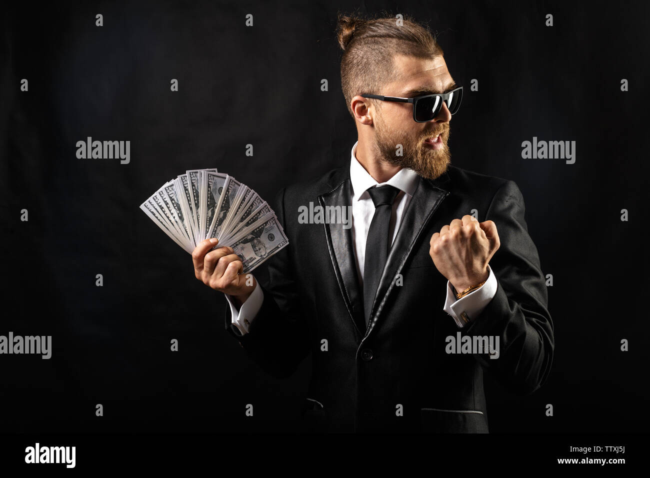 Man holding Money in hand at Black Background Stock Photo - Alamy