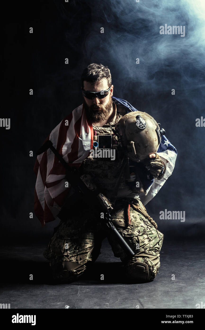 Soldier holding machine gun with national flag Stock Photo - Alamy