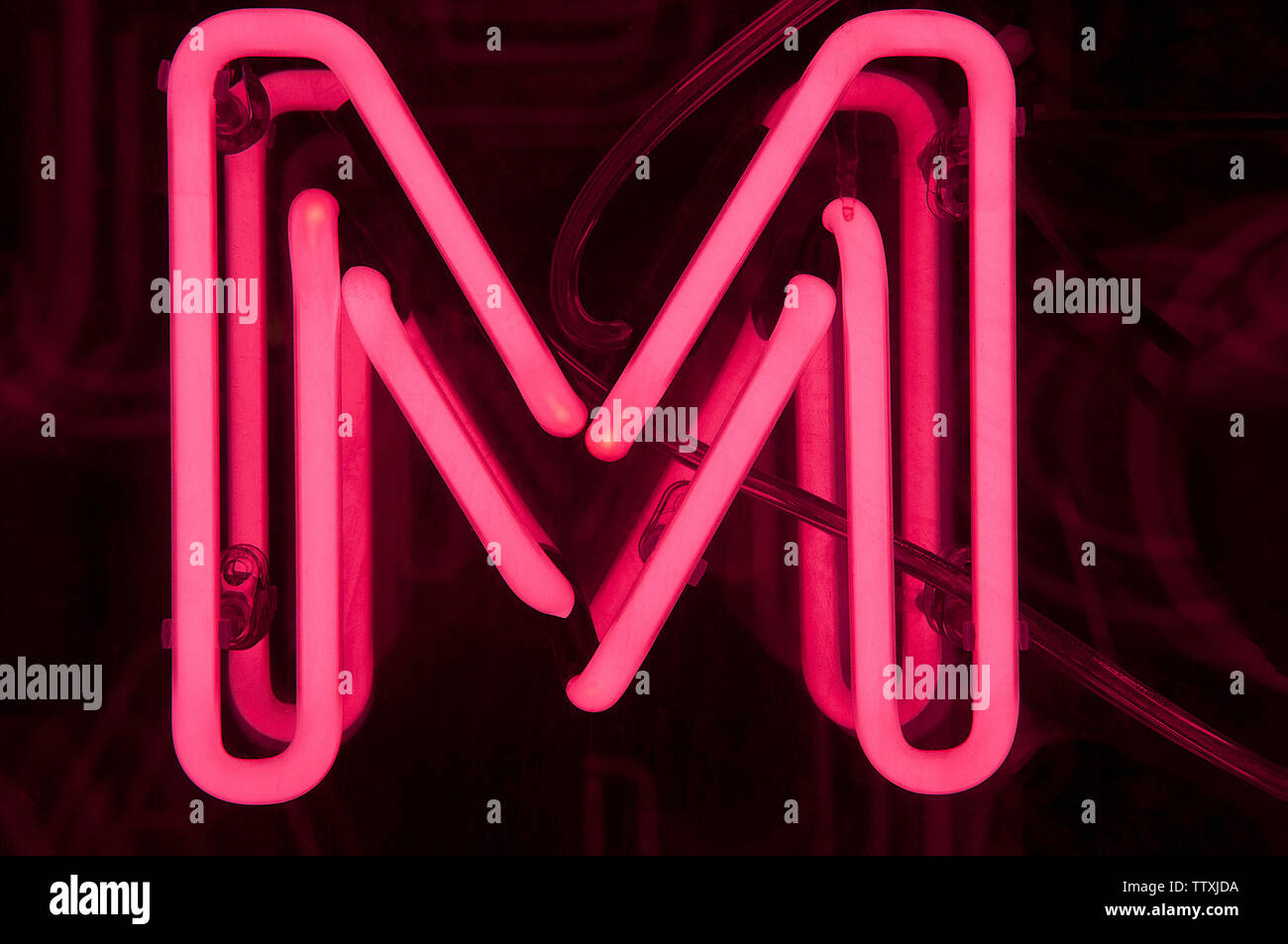 A Close Up Of A Lit Neon Letter M Stock Photo - Alamy