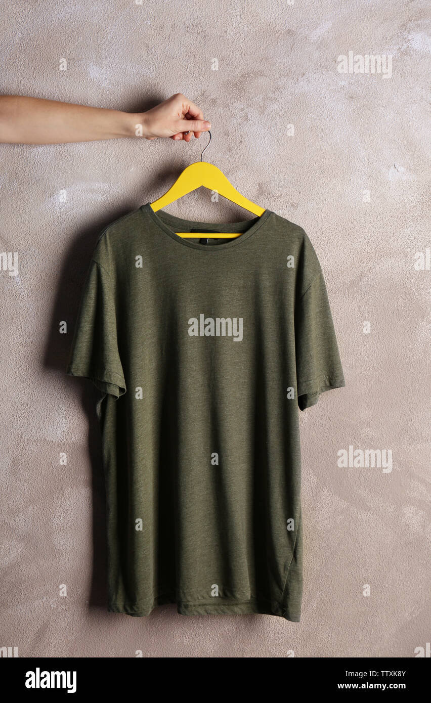 Blank color t-shirt against grunge background Stock Photo - Alamy