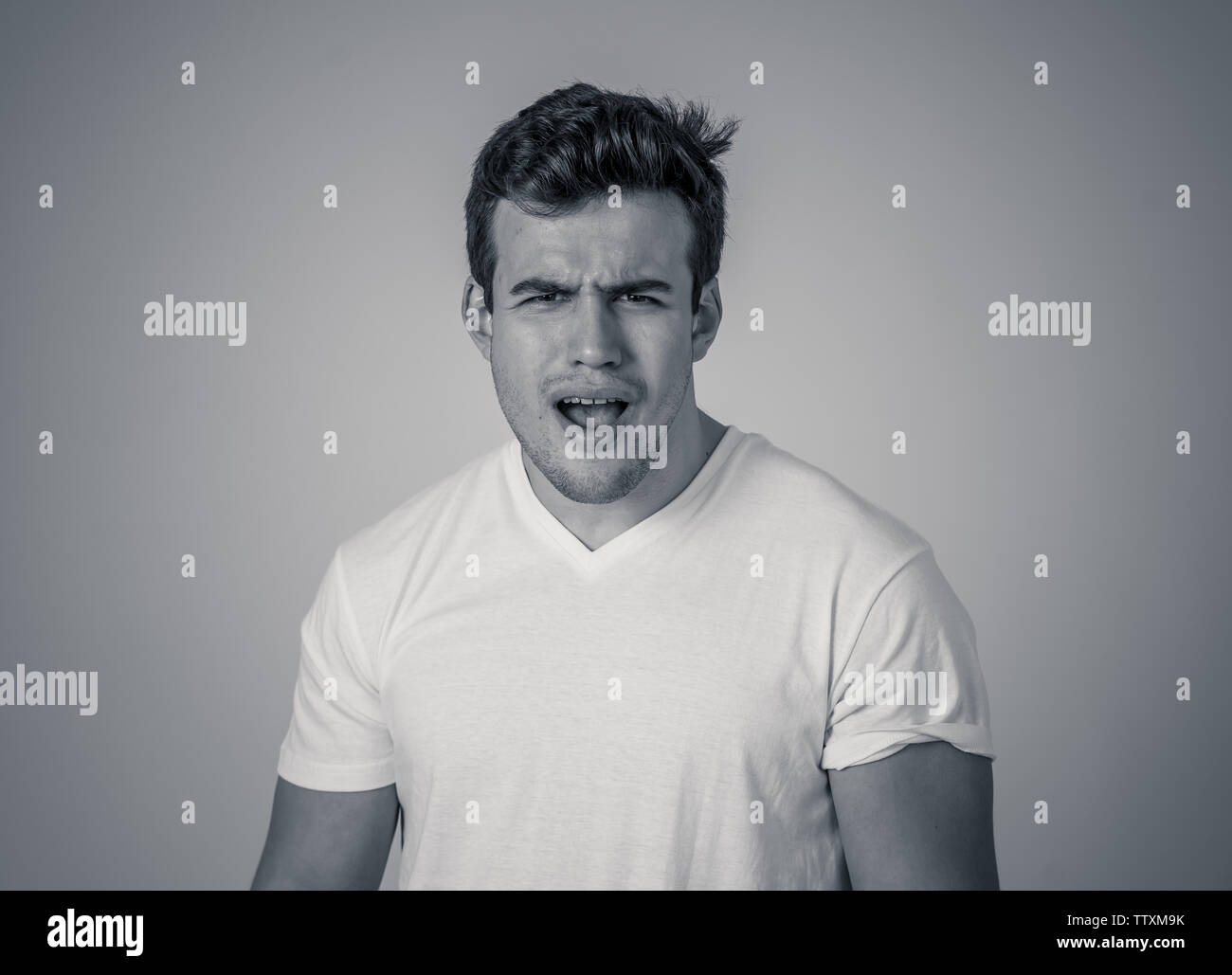 Portrait of handsome shocked young man hearing unexpected news. latin ...