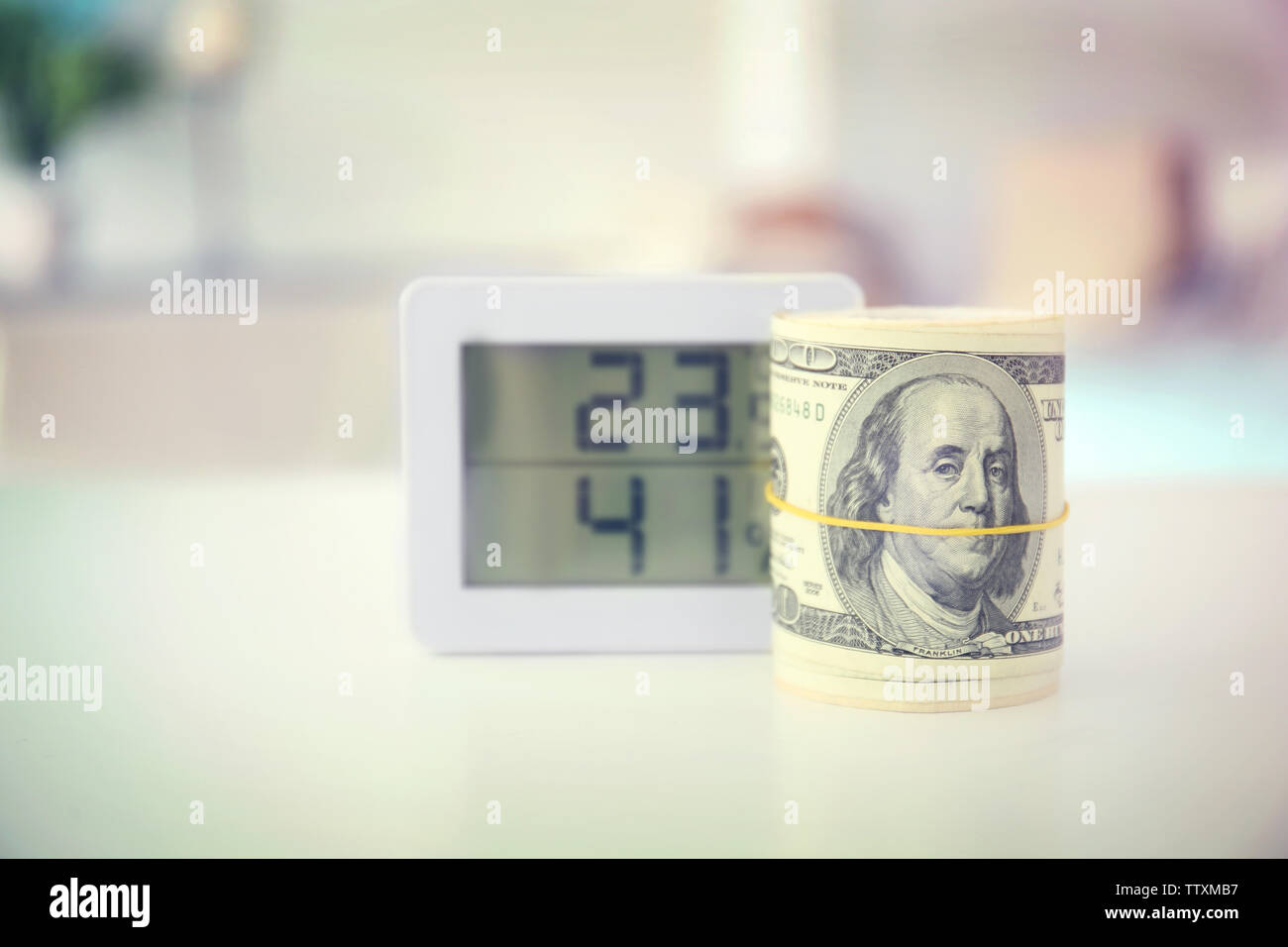 Savings concept. Money and electronic thermometer on table Stock Photo ...