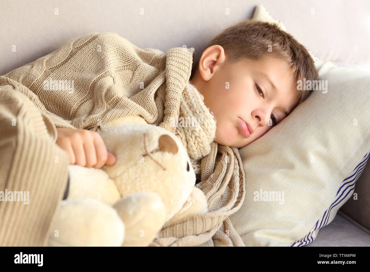 Small sick boy in bed Stock Photo - Alamy