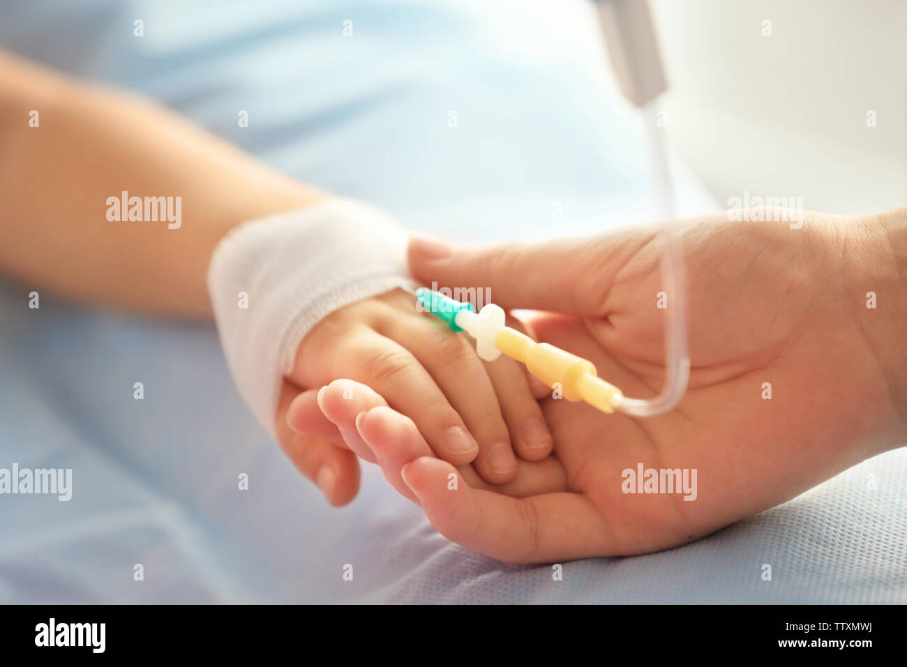 Child hand with catheter on bed Stock Photo - Alamy