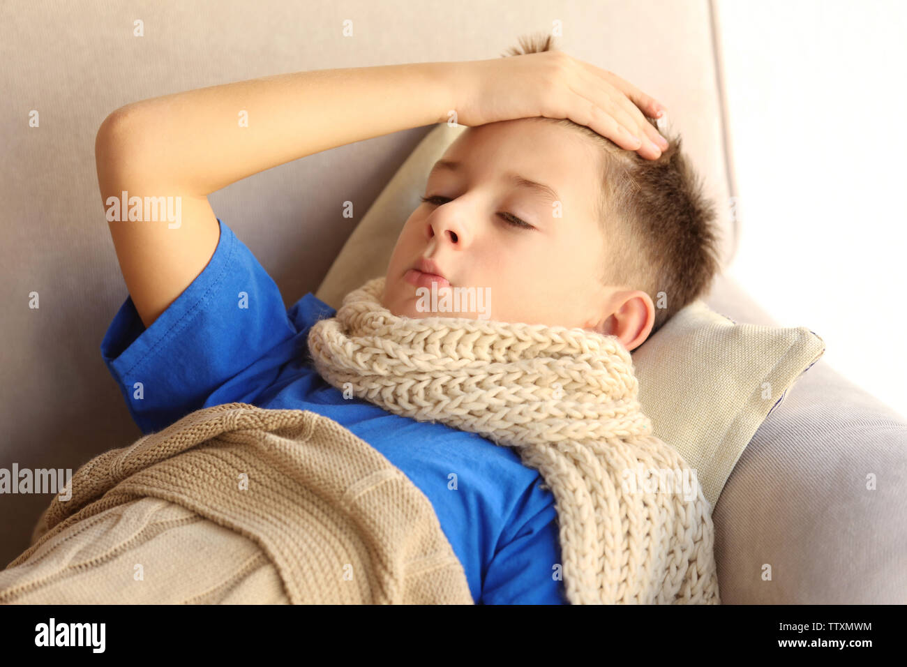 Small sick boy in bed Stock Photo - Alamy