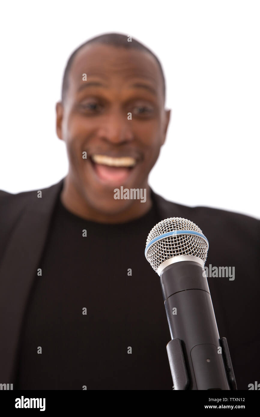 Handsome african american singer with microphone on white Stock Photo ...