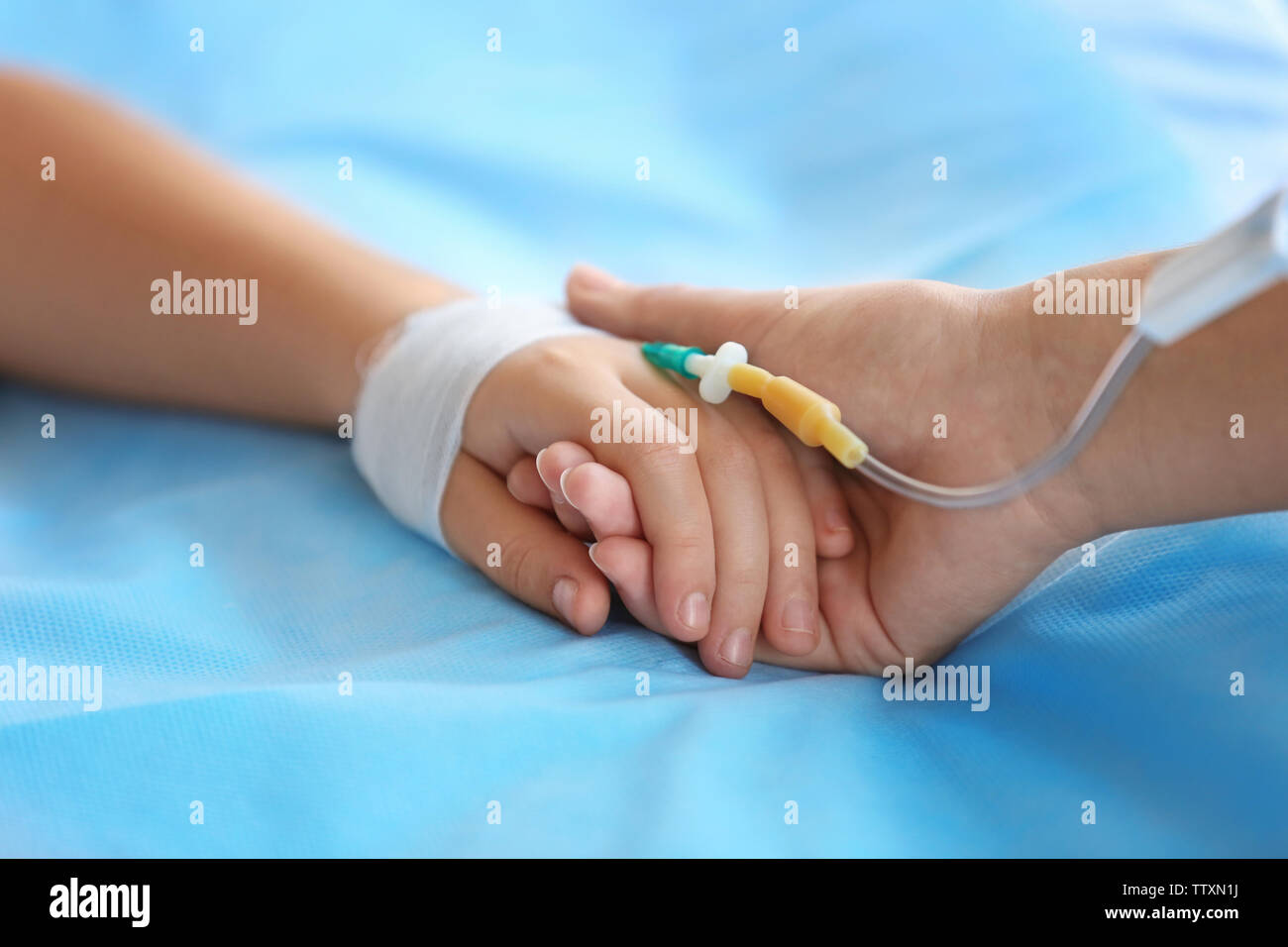 Child hand with catheter on bed Stock Photo - Alamy