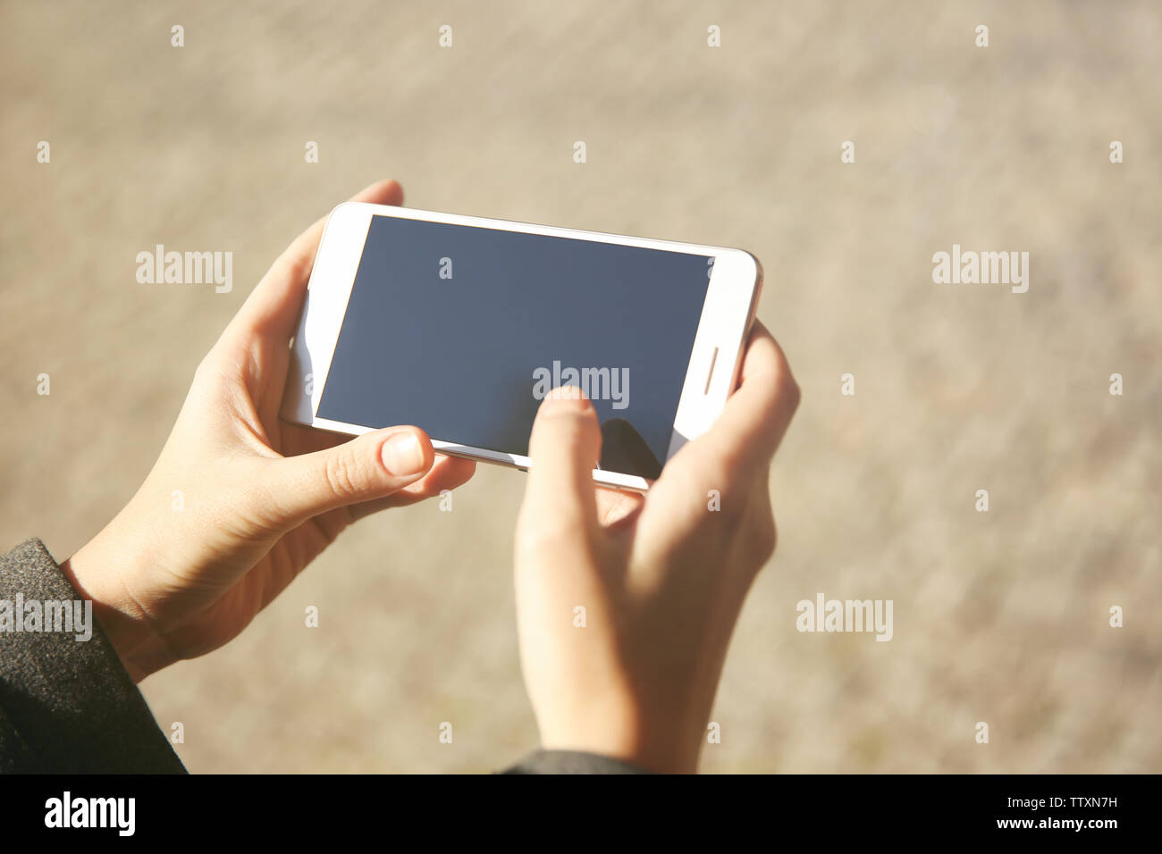 Woman holding modern cellphone, outdoor Stock Photo - Alamy