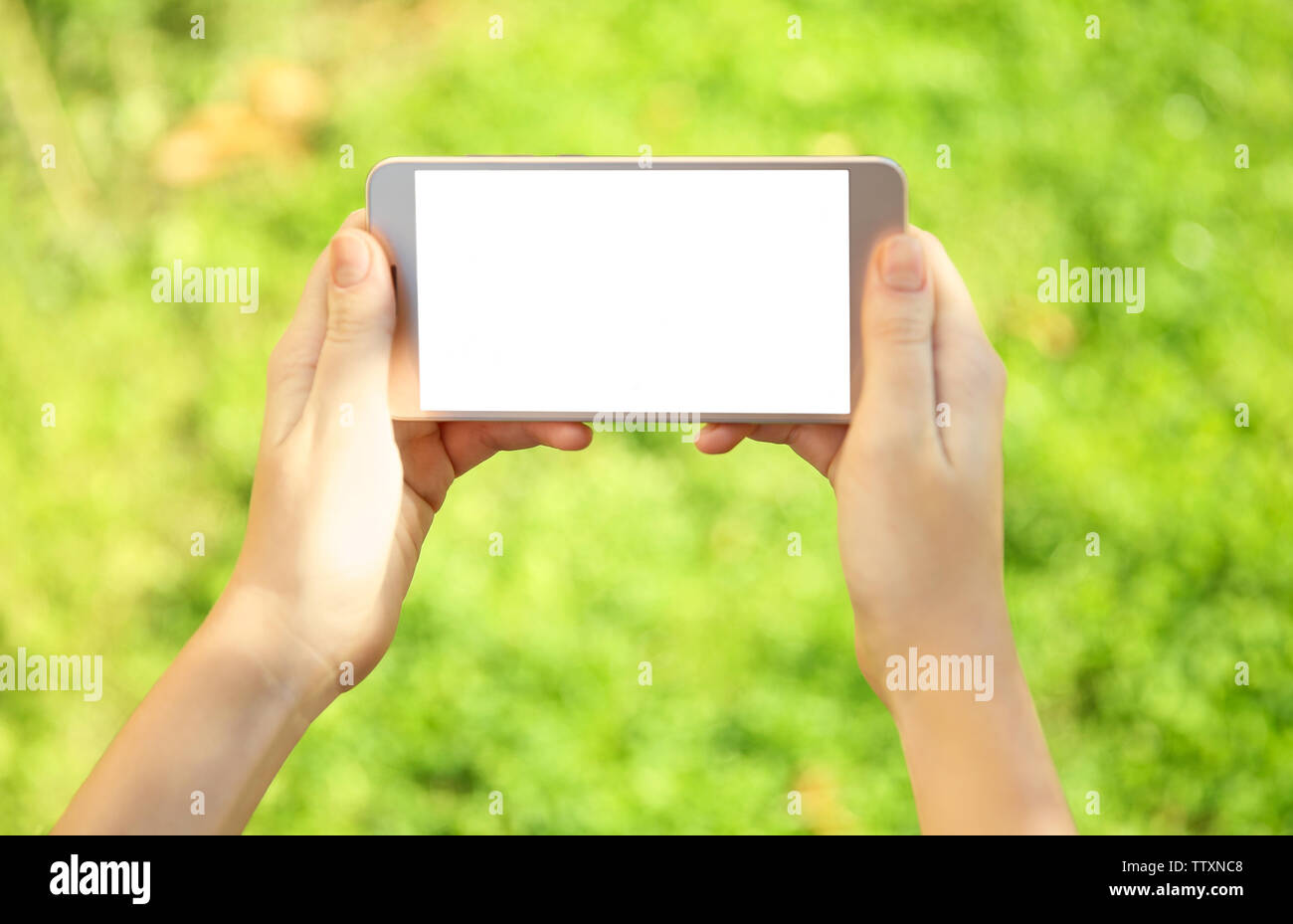 Woman holding modern cellphone, outdoor Stock Photo - Alamy