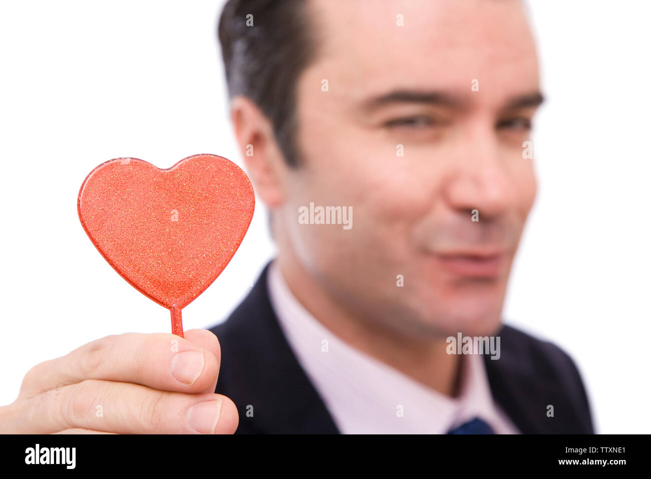 romance concept with a handsome man holding heart shape on white Stock ...