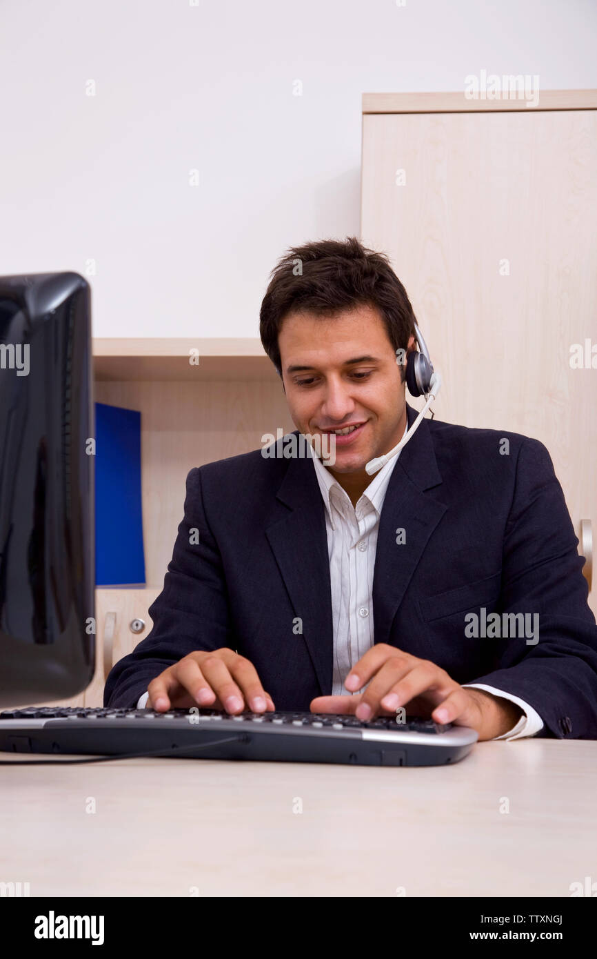 Customer service representative at the office with computer Stock Photo ...