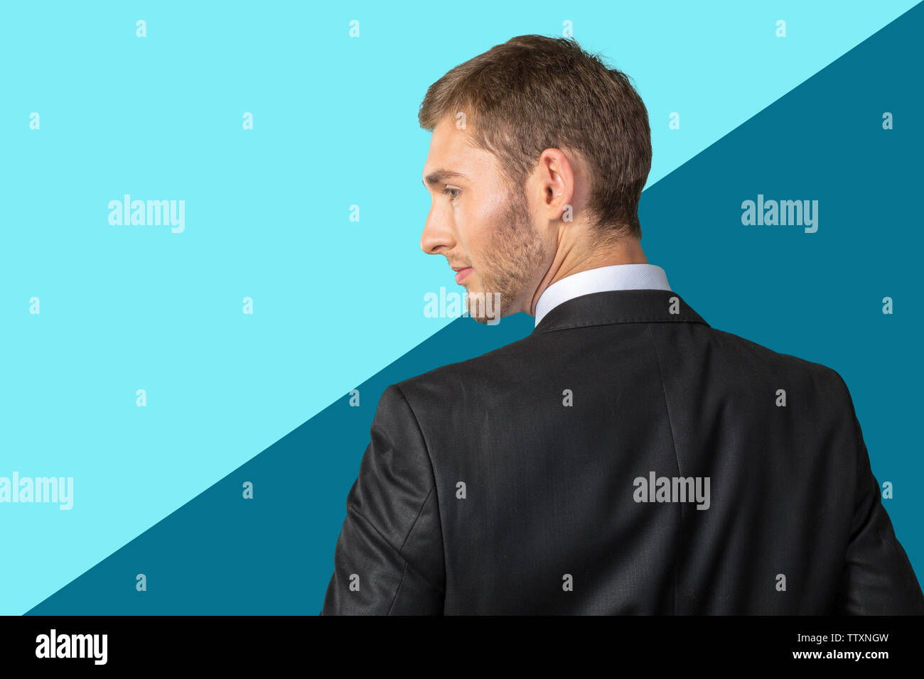Young Businessman looking over his shoulder Stock Photo - Alamy