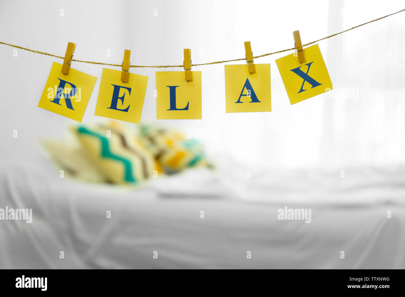 Cards with printed word RELAX on blurred room background Stock Photo ...