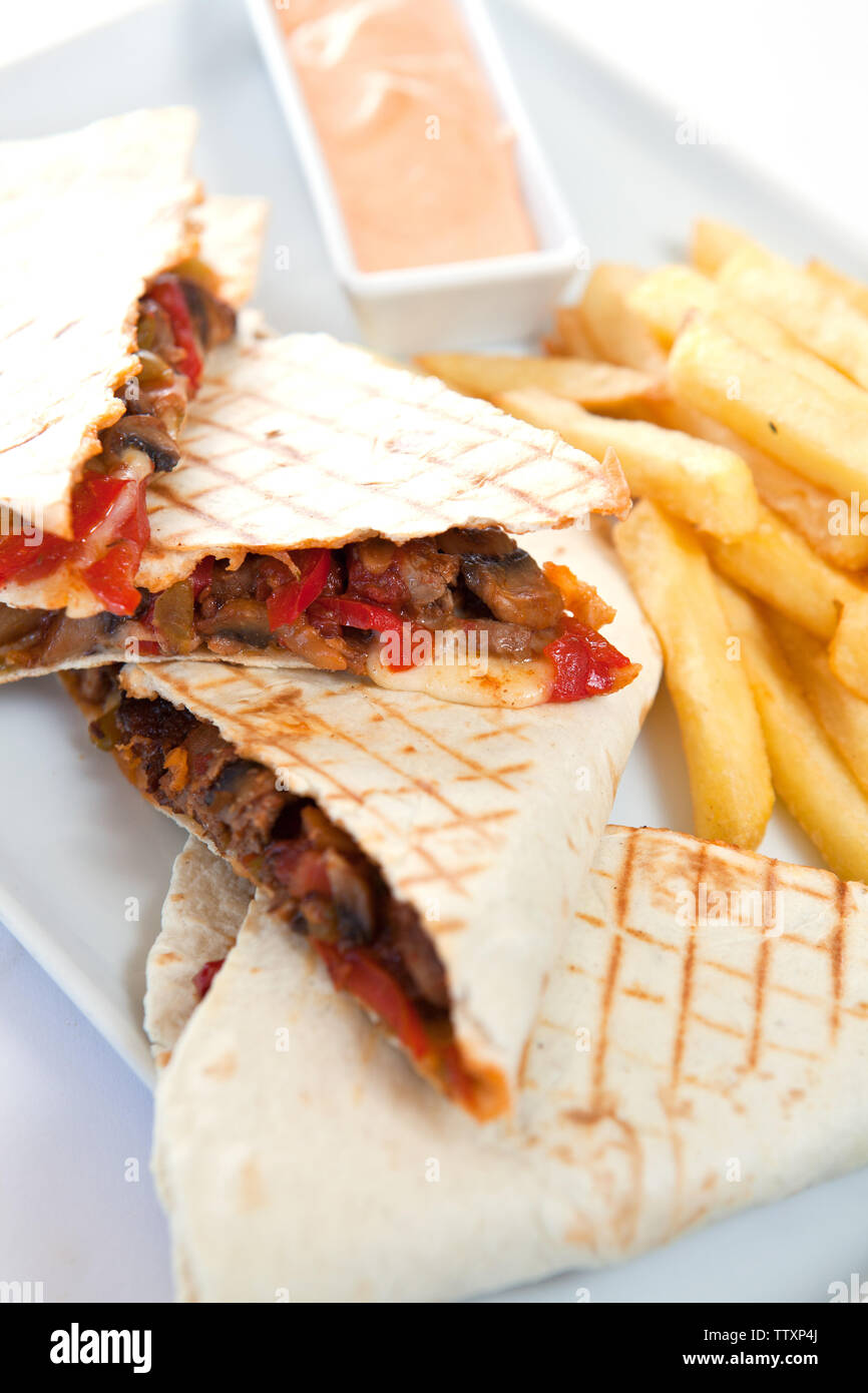 Stuffed crepes with fried chips and sauce Stock Photo - Alamy
