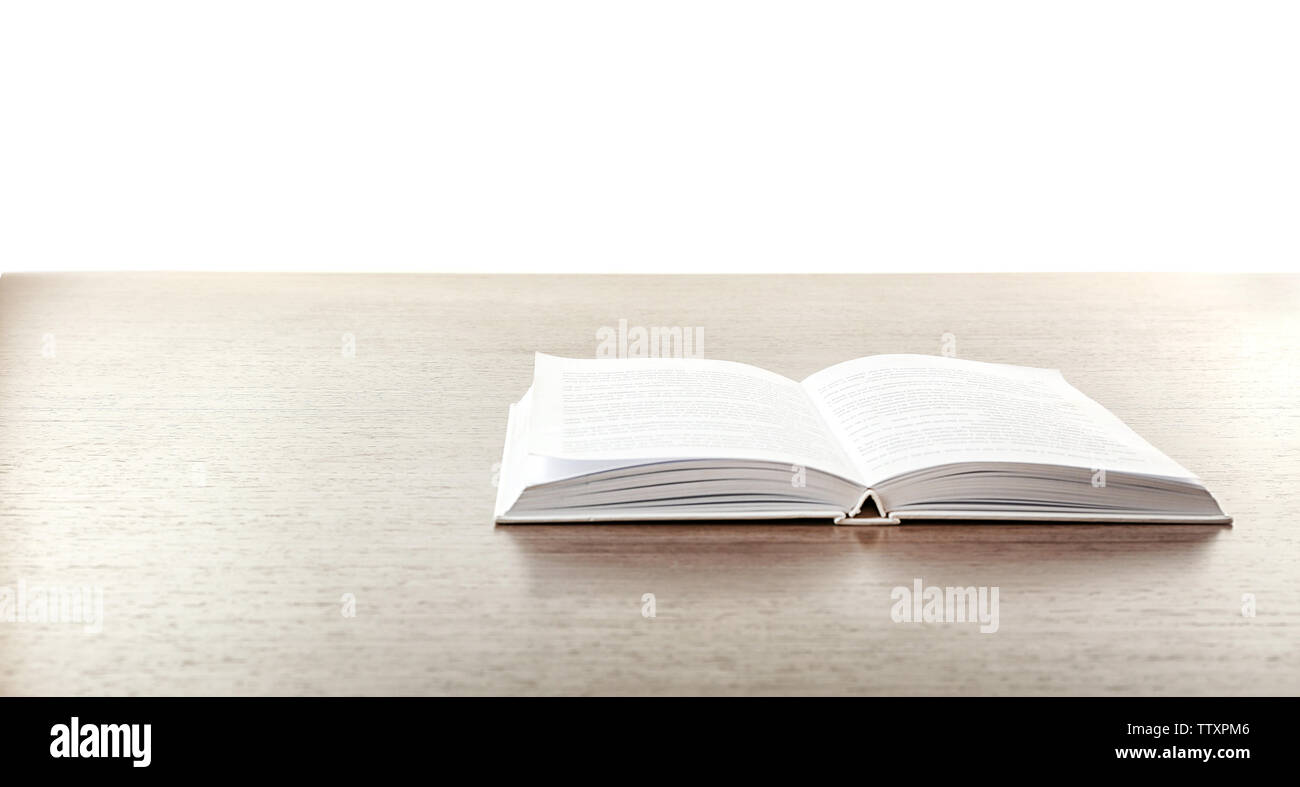 Open book on wooden table Stock Photo - Alamy
