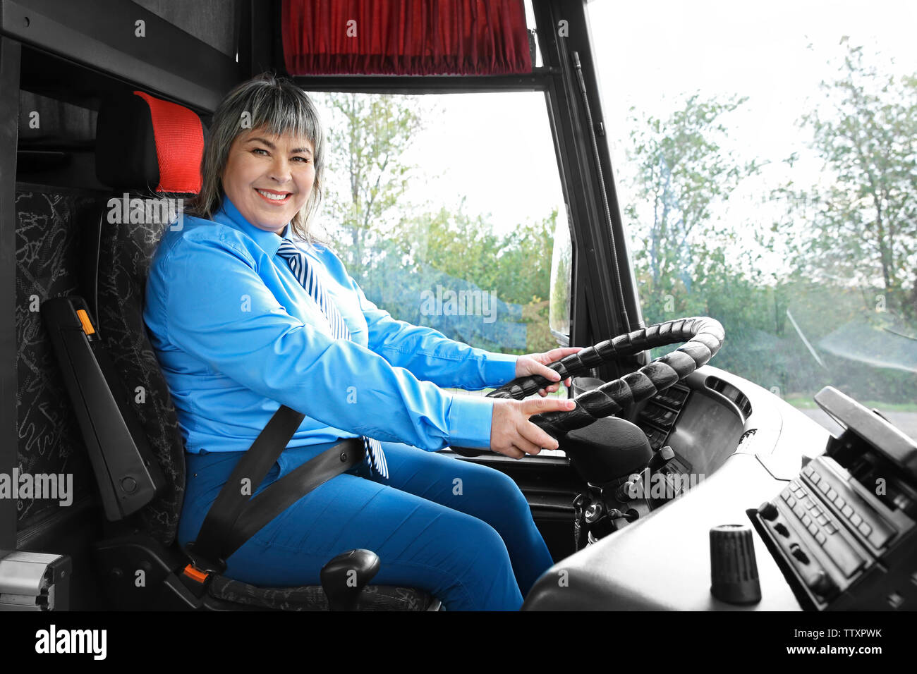 Female driver sitting in bus Stock Photo - Alamy