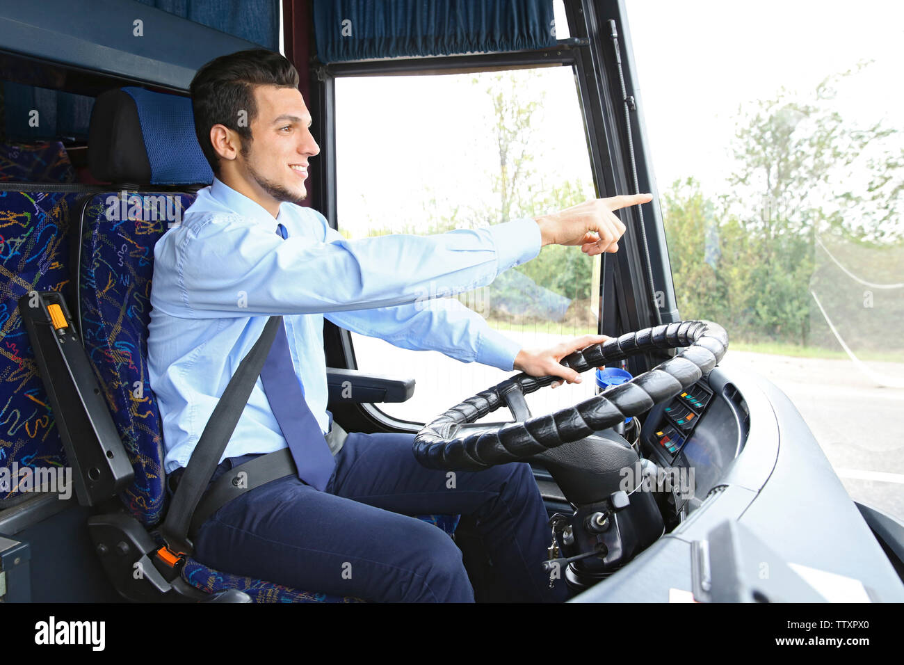 Handsome driver sitting in bus Stock Photo - Alamy