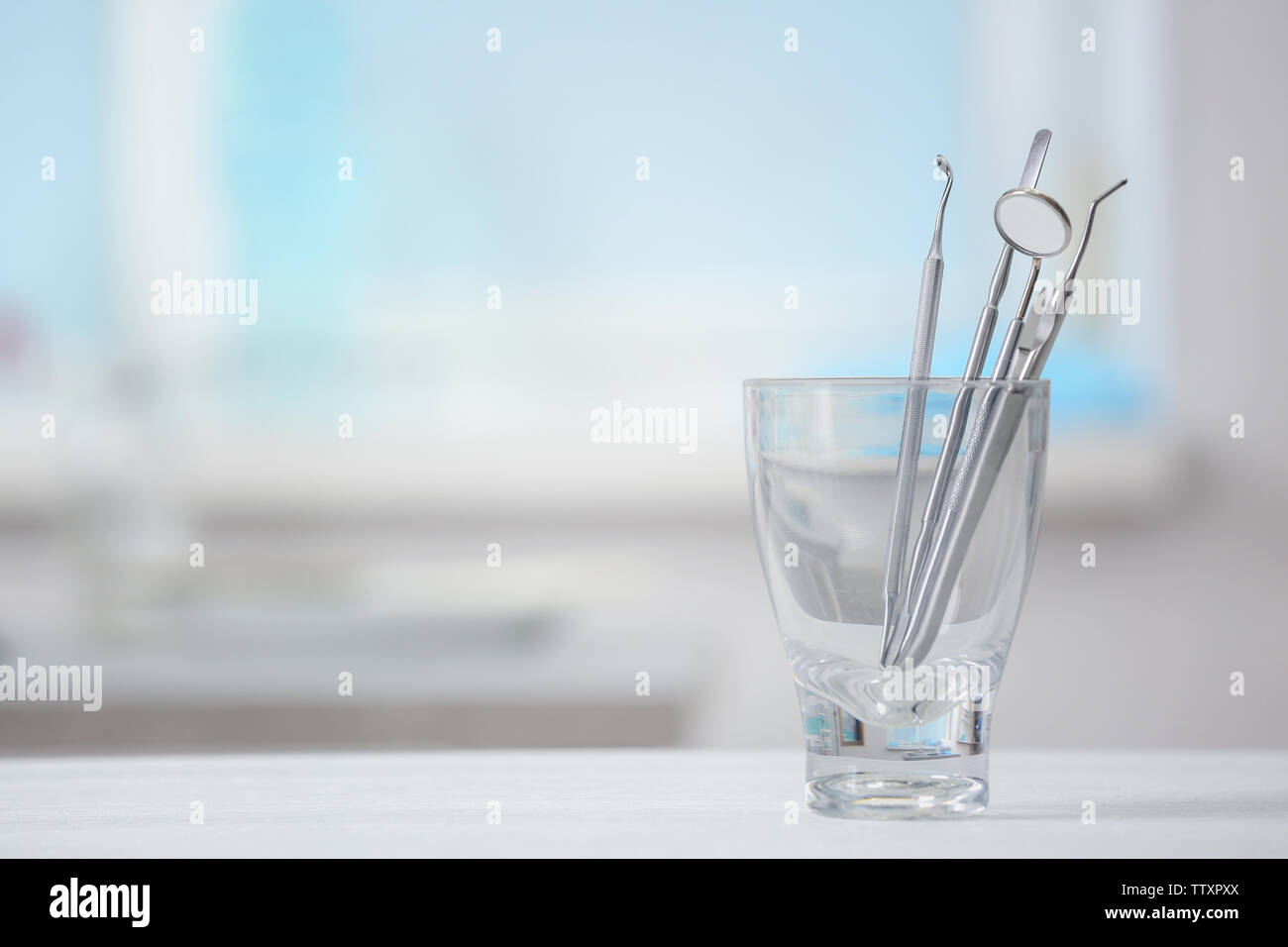 Dentist medical tools in glass Stock Photo - Alamy