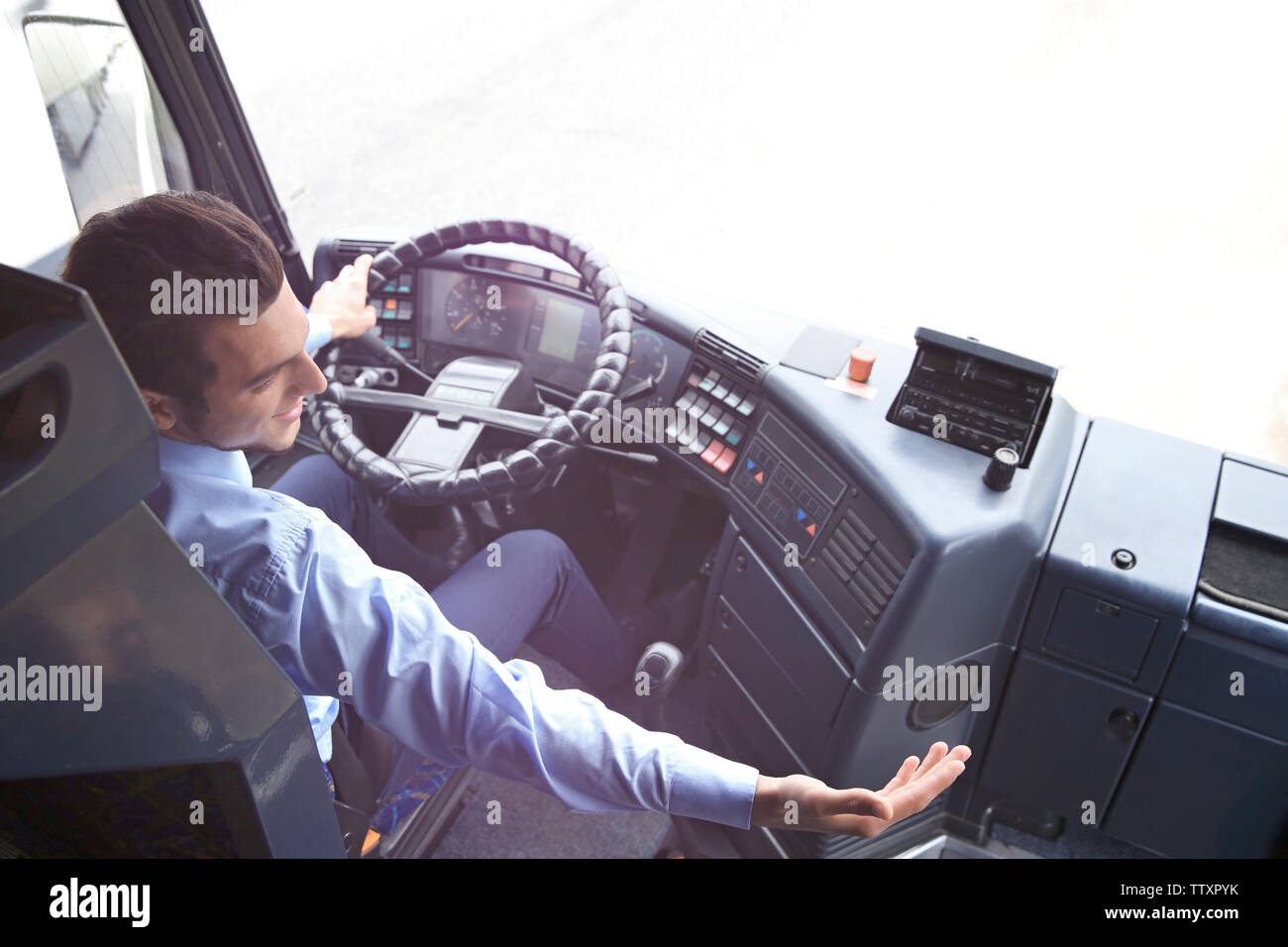 Handsome driver sitting in bus Stock Photo - Alamy