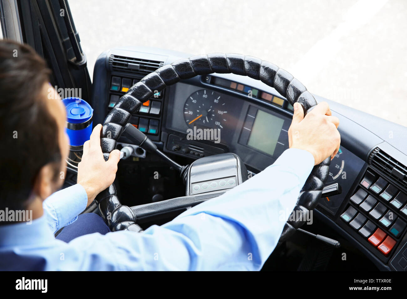 Handsome driver sitting in bus Stock Photo - Alamy