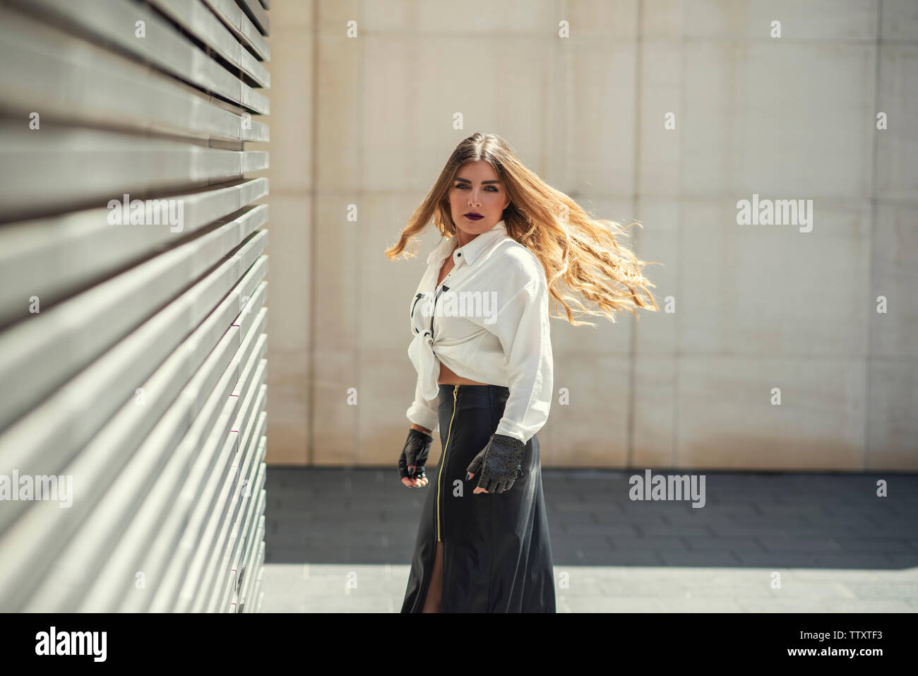 Beautiful woman flicking hair outdoors Stock Photo - Alamy